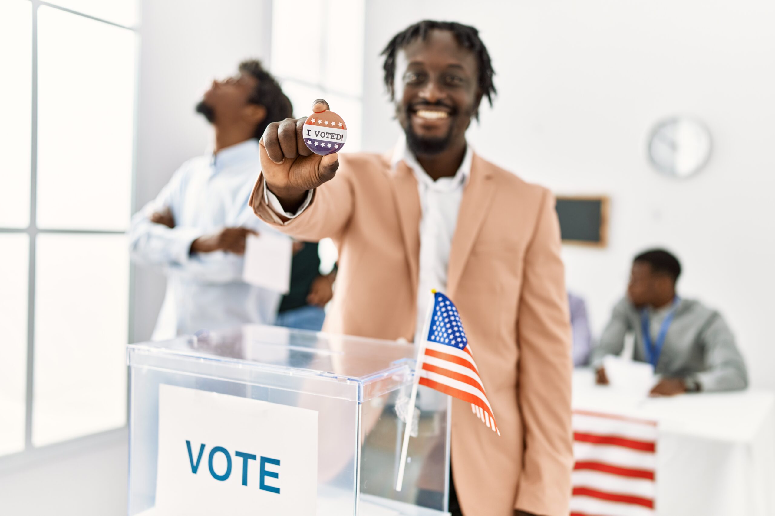 Young american voter man smiling happy holding i voted badge at ...