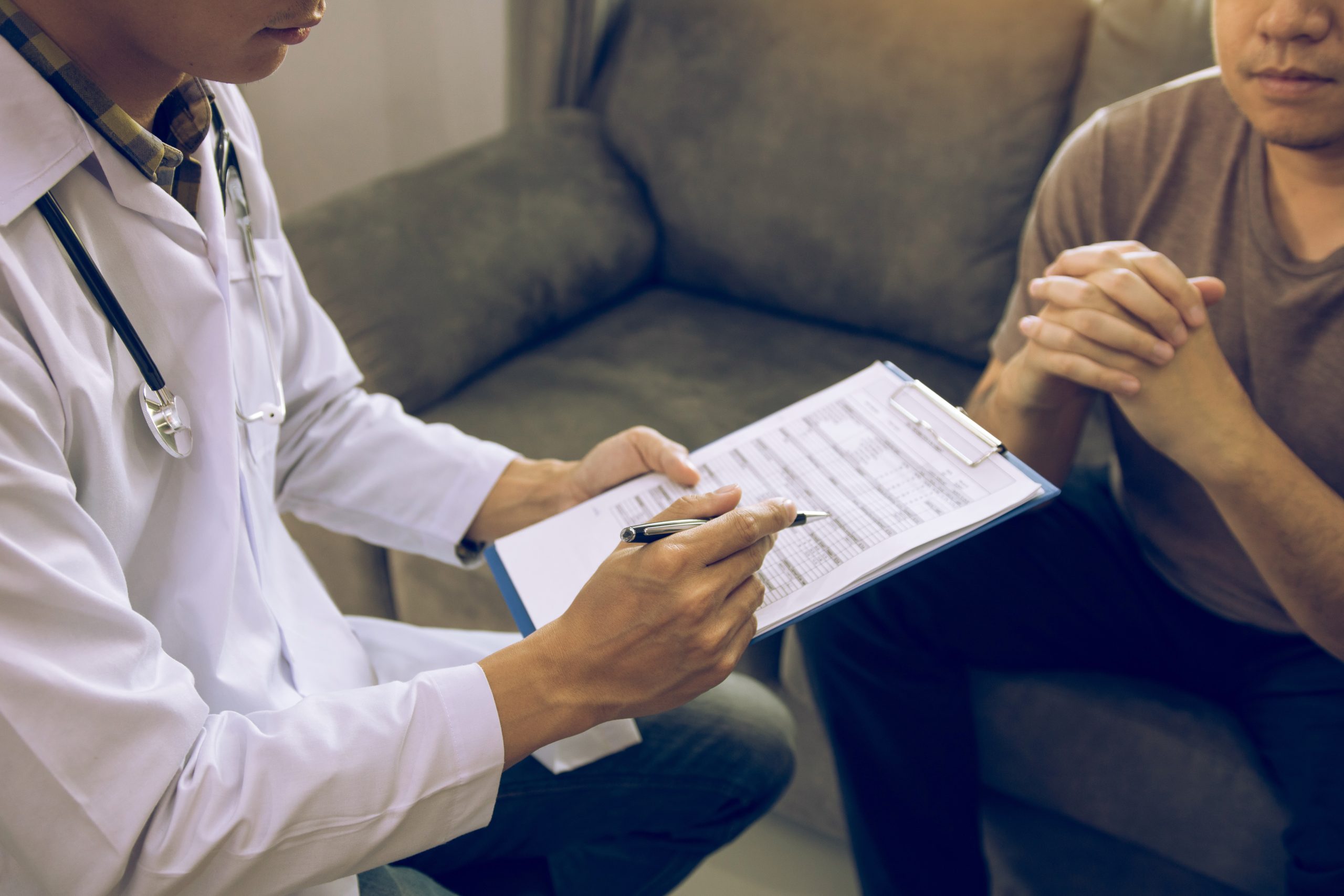 Asian doctor is examining the abnormal items of the body and diagnosing ...